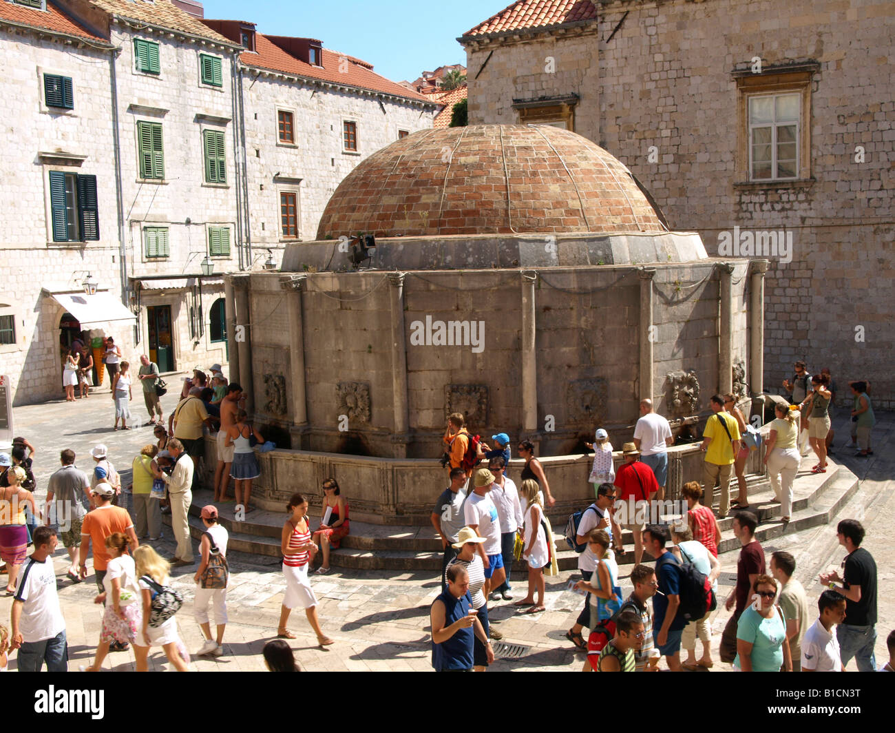tourists at a well on the main square in the old town of Dubrovnik ...