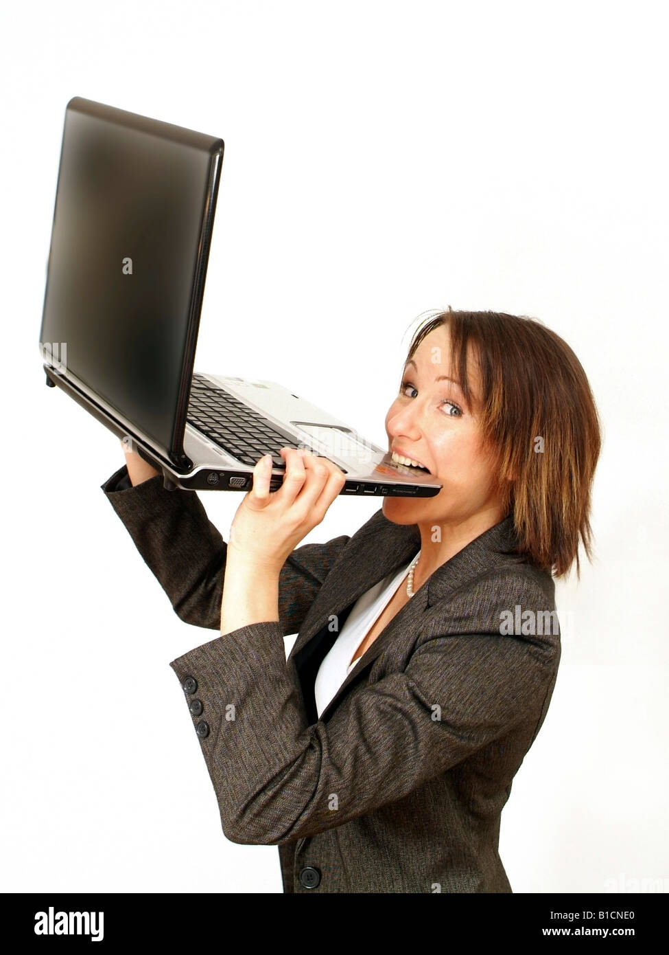 young business woman bites into laptop Stock Photo - Alamy