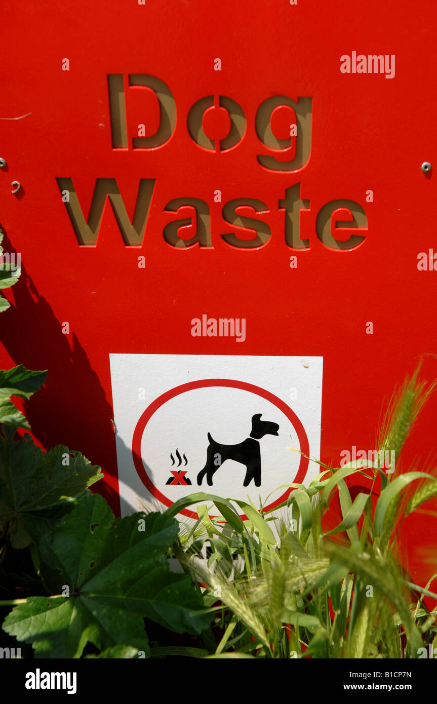 Bright red dog waste bin UK Stock Photo - Alamy