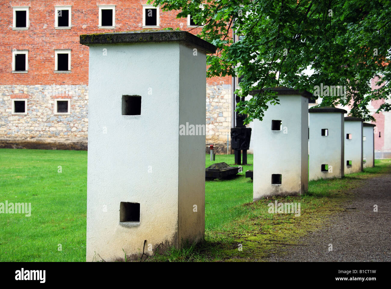 Path to the old castle with concrete fence and old wall behind it Stock ...