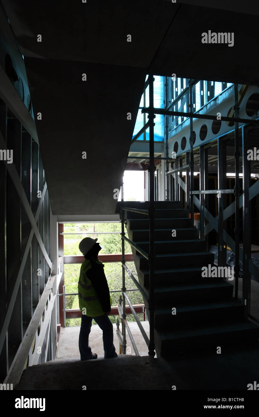 Construction worker in hard hat, high vis jacket inside a new ...