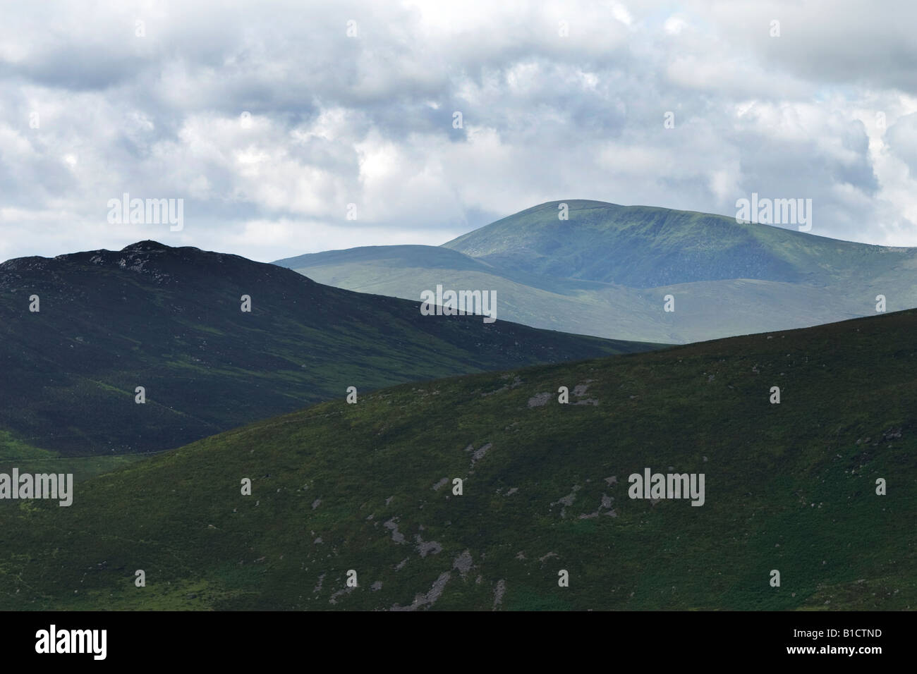 Overlapping mountains in Wicklow Ireland with cloudy sky Stock Photo ...