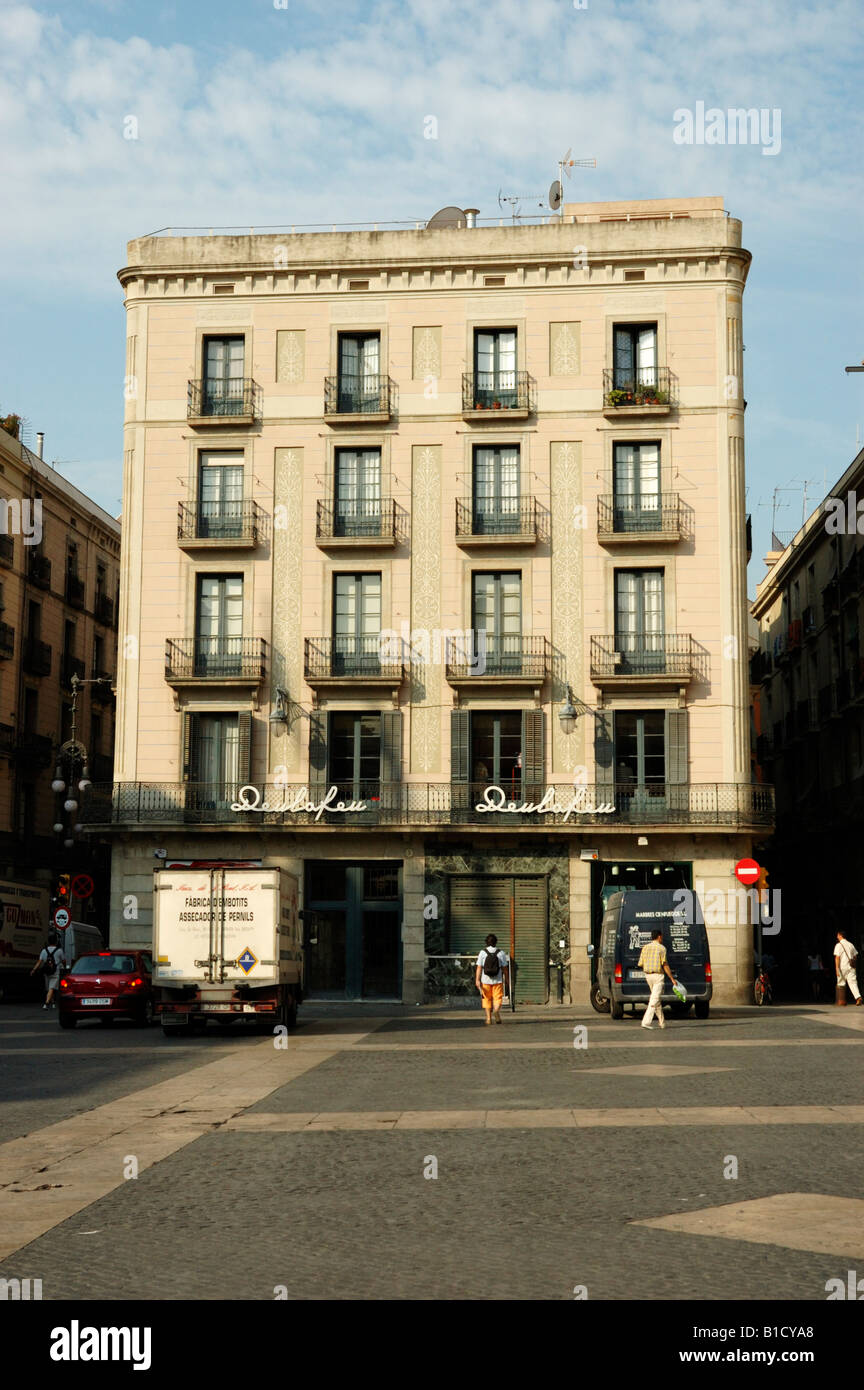 Shops and an Apartment Block set in a cobbled Square in Barcelona Stock ...