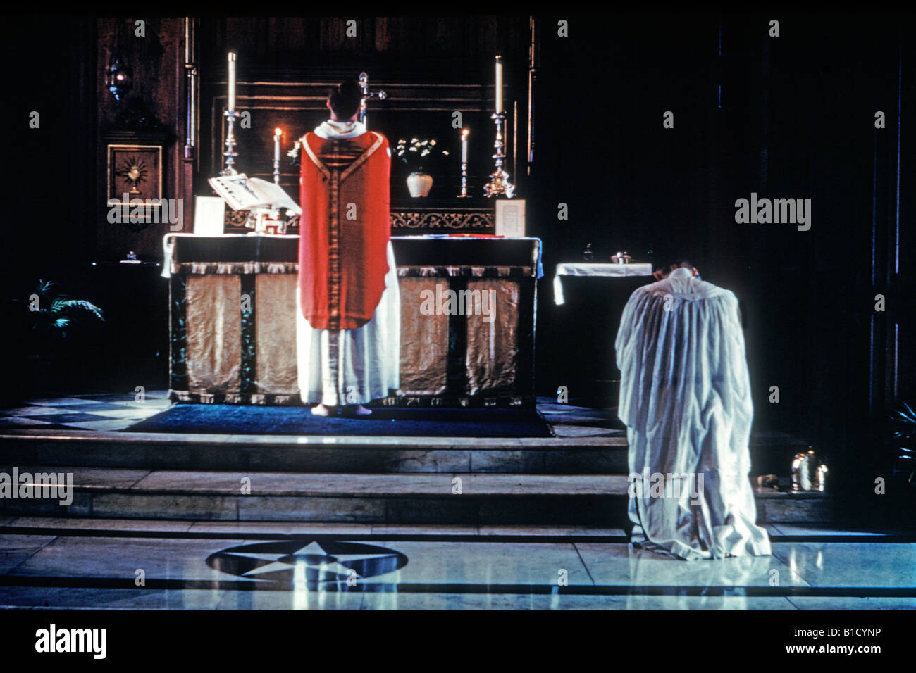 priest celebrating mass in front of altar Stock Photo - Alamy