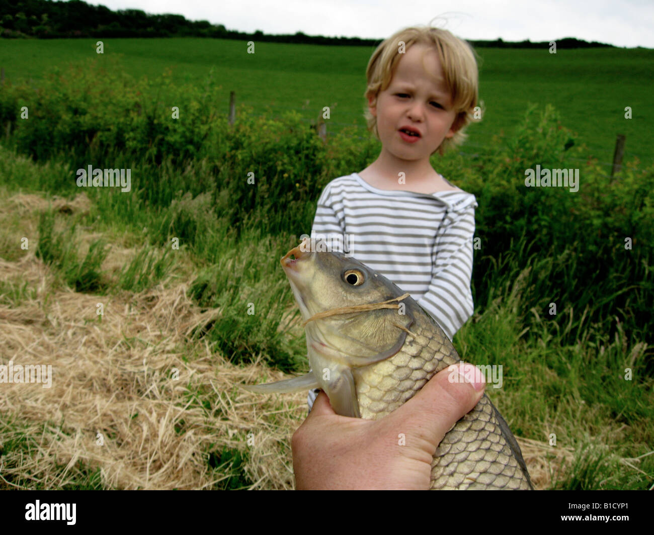 Child and carp hi-res stock photography and images - Alamy