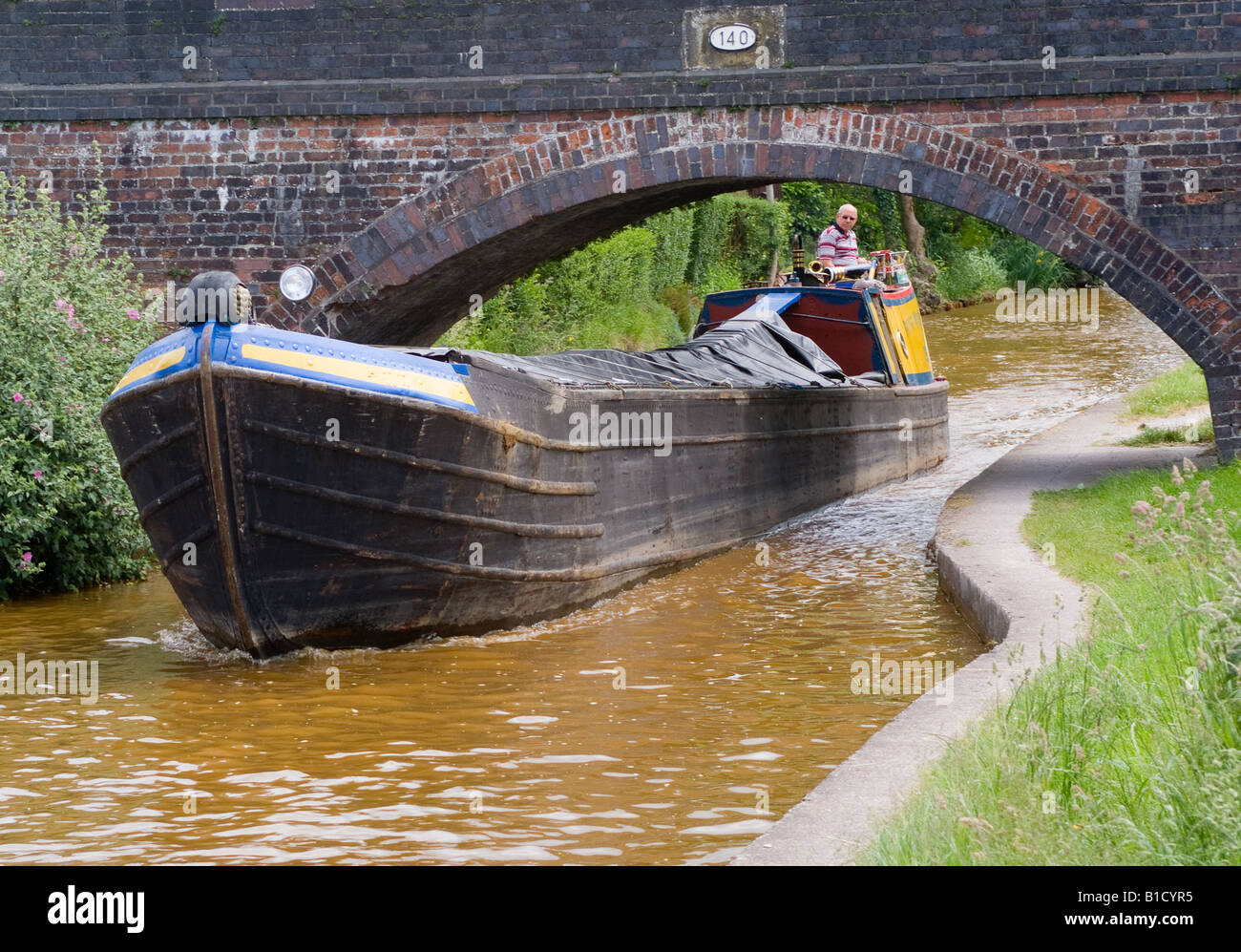 Old British Waterways Working Narrow Boat On Trent And Mersey Canal Passing Under Bridge Near Rode
