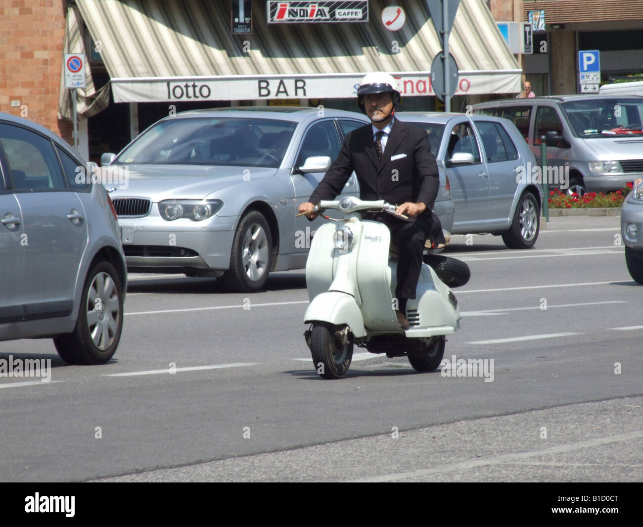 business man riding vespa type scooter in italy Stock Photo - Alamy
