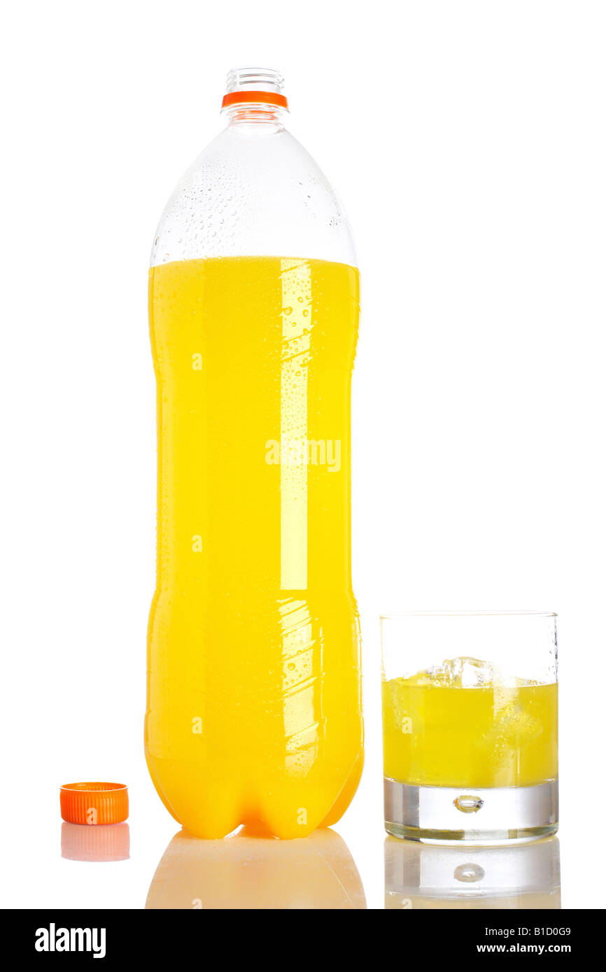 Bottle and glass of orange soda with droplets reflected on white ...