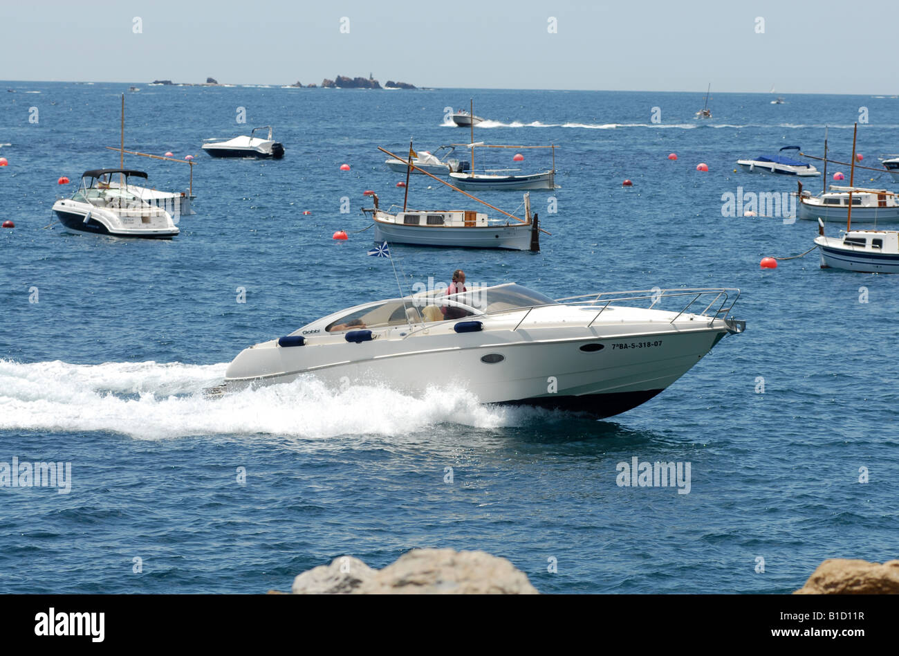 Speed boat coming into the harbour at Llafranc on the Costa Brava Spain ...