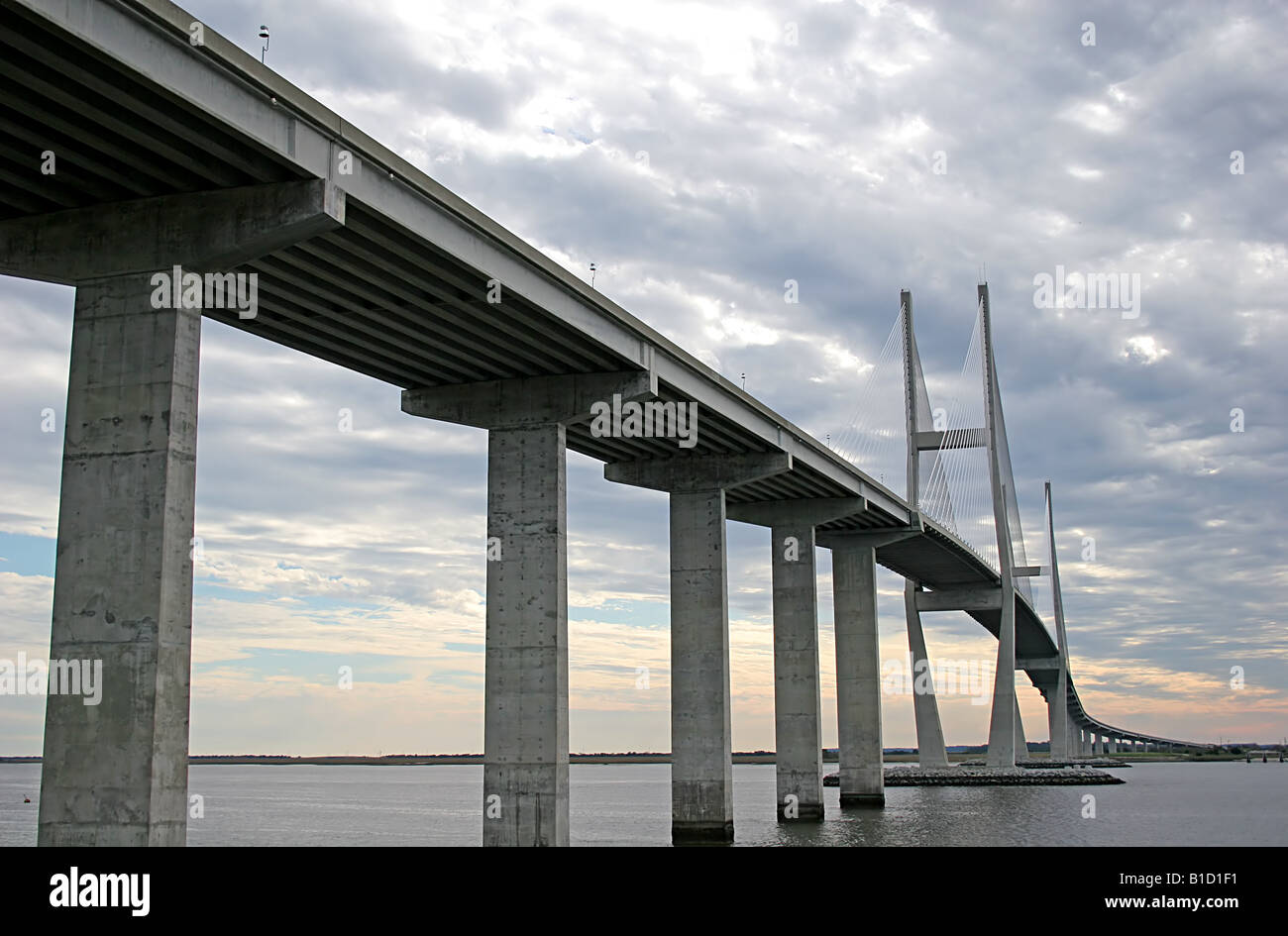 A new concrete and suspension bridge crossing into the distance over ...