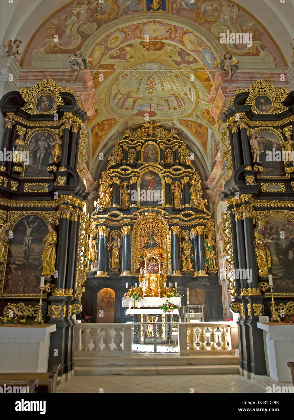 interior view of the baroque church with golden altar in the cloister ...