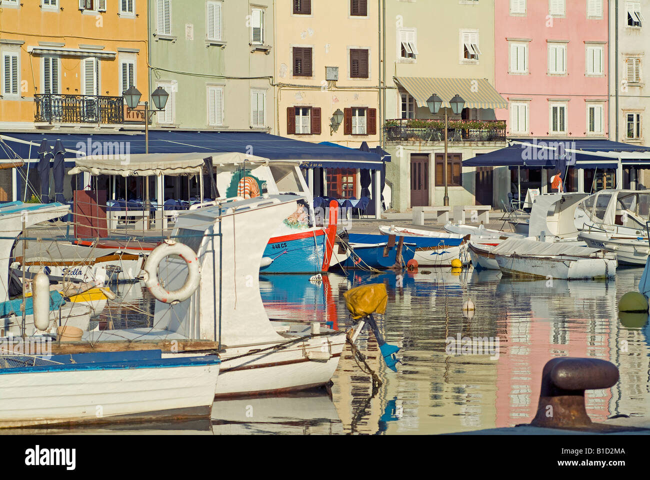 pastel coloured houses reflecting on water of Port bassin with fisher ...