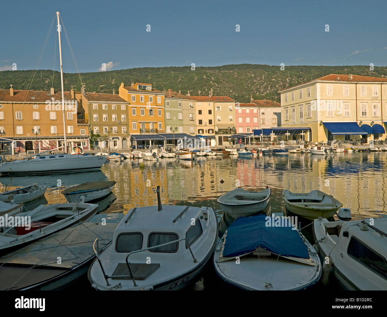 pastel coloured houses reflecting on water of Port bassin with fisher ...