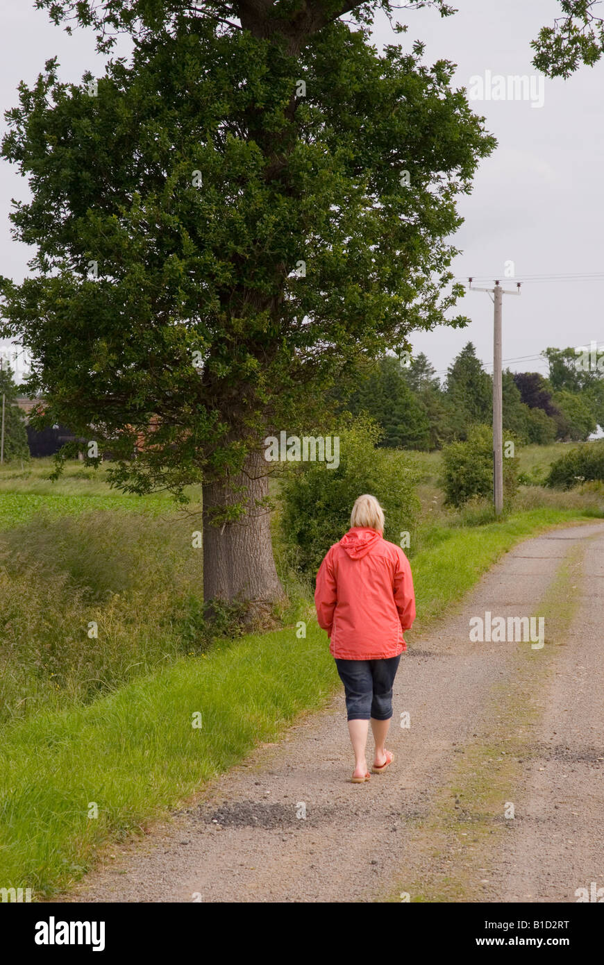 Woman walking along pathway hi-res stock photography and images - Alamy