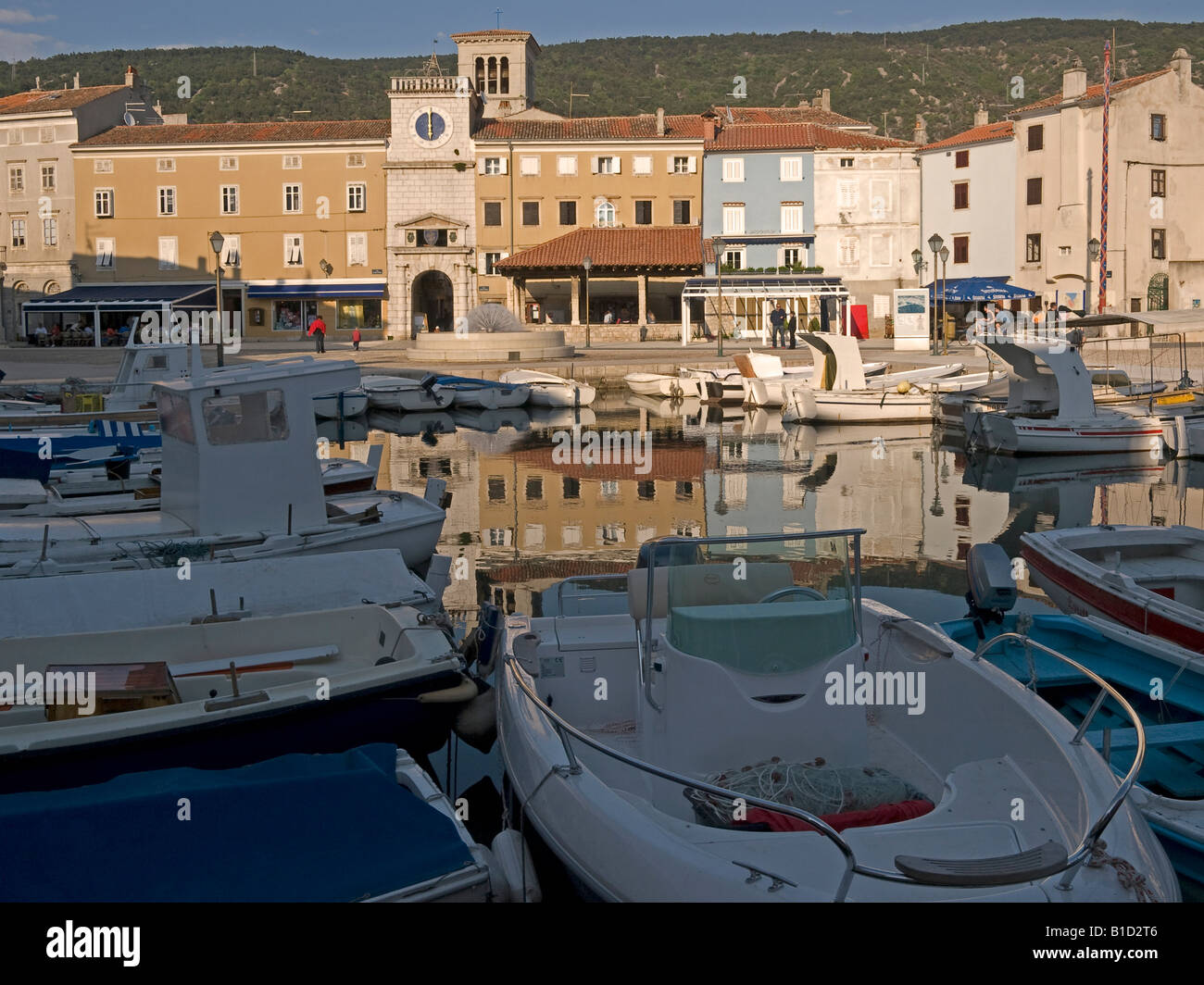 pastel coloured houses reflecting on water of Port bassin with fisher ...