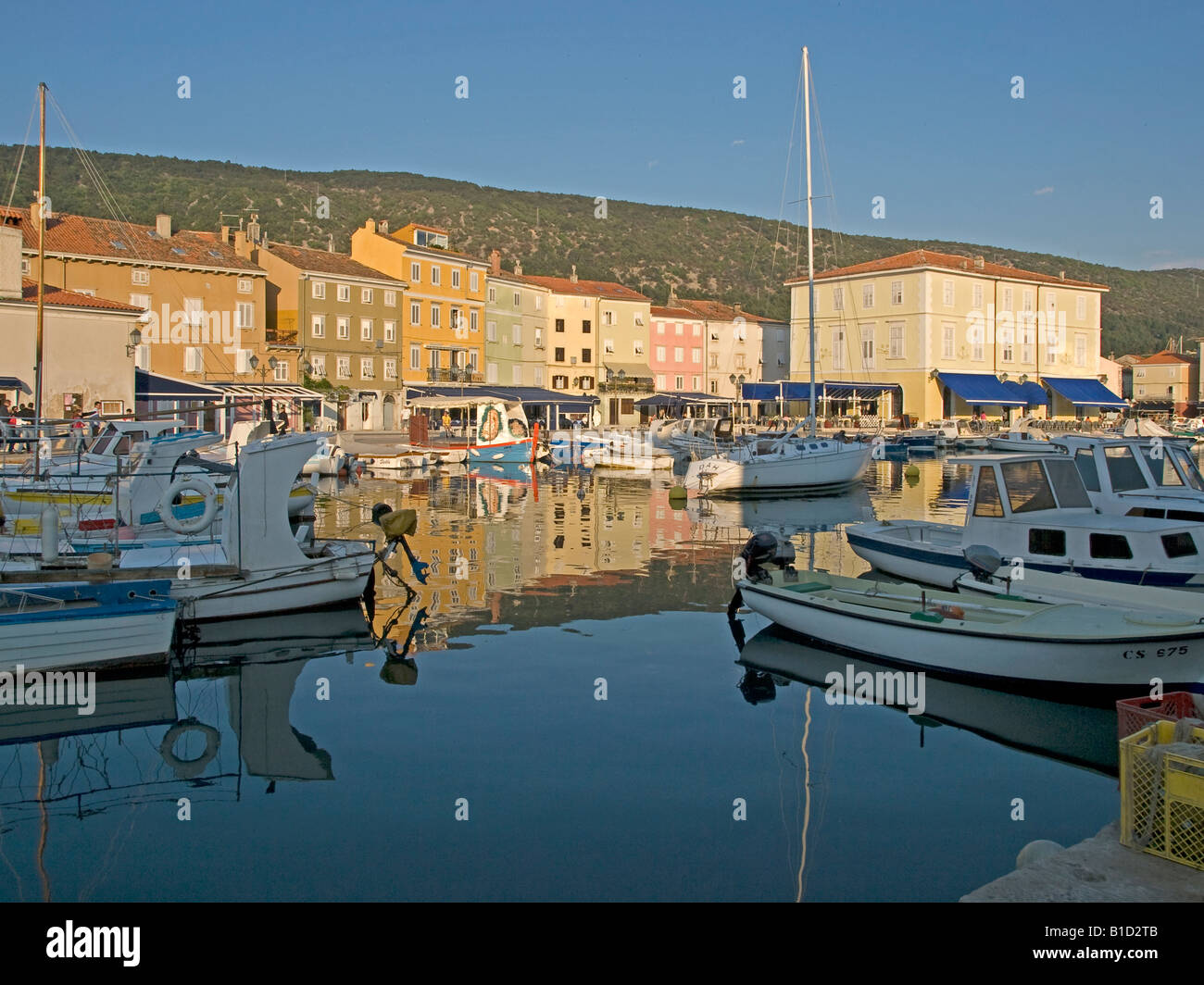 pastel coloured houses reflecting on water of Port bassin with fisher ...