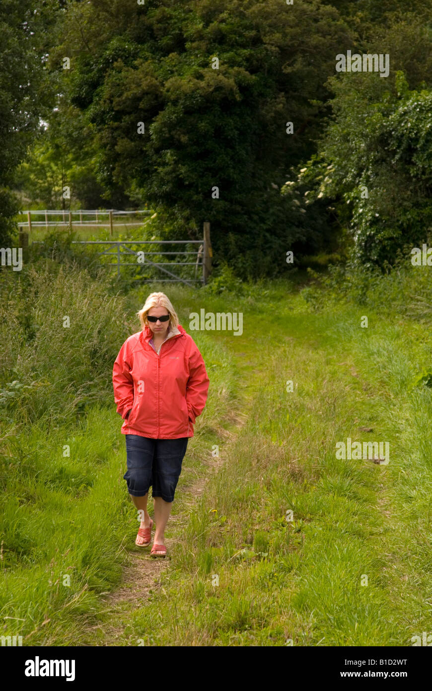Woman walking along pathway hi-res stock photography and images - Alamy