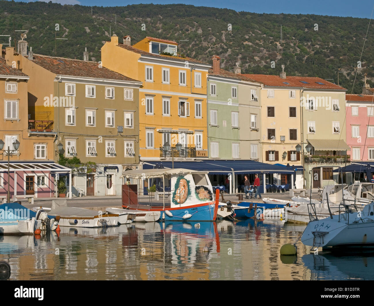 pastel coloured houses reflecting on water of Port bassin with fisher ...