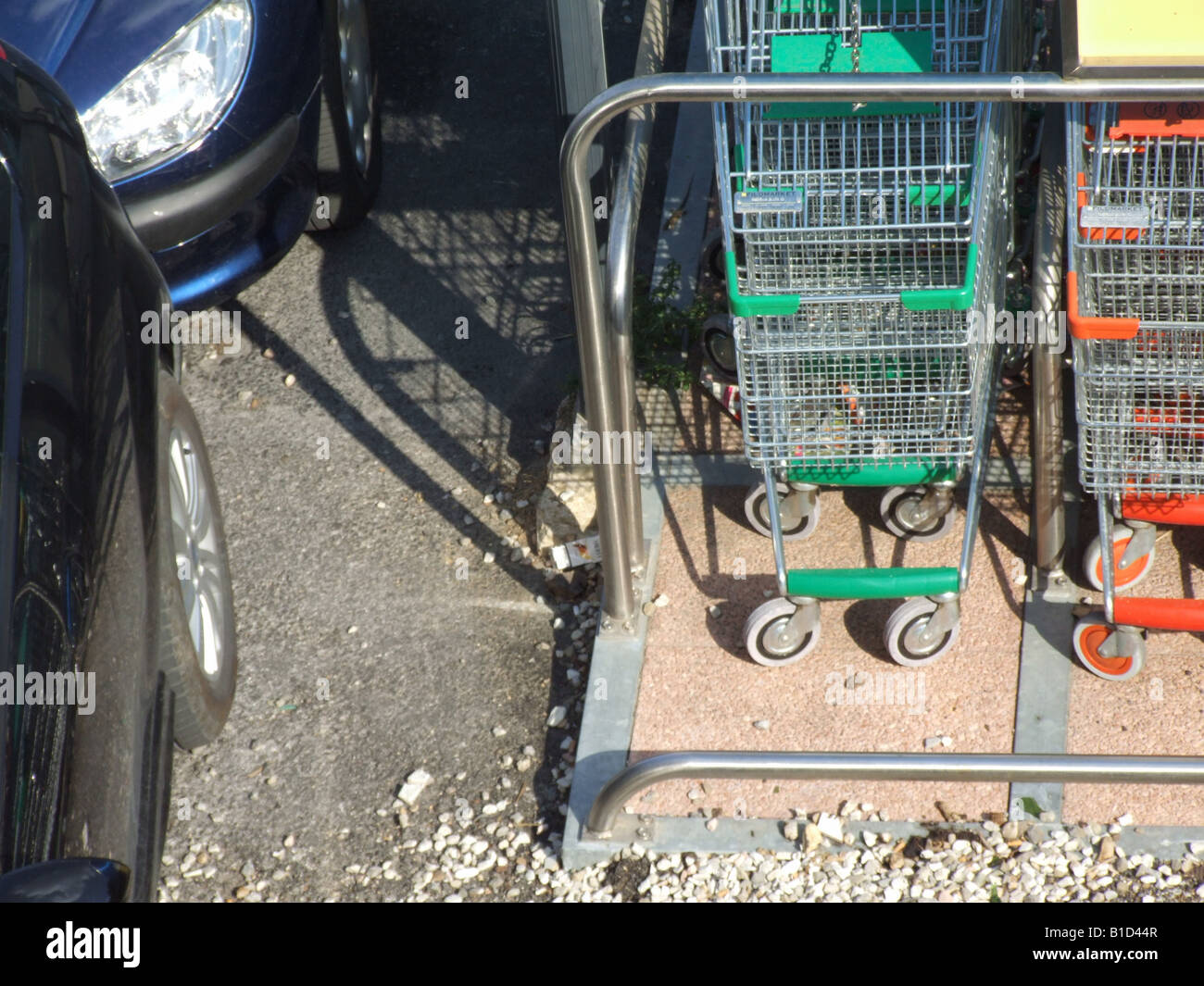 metal shopping trolleys in supermarket car park Stock Photo - Alamy