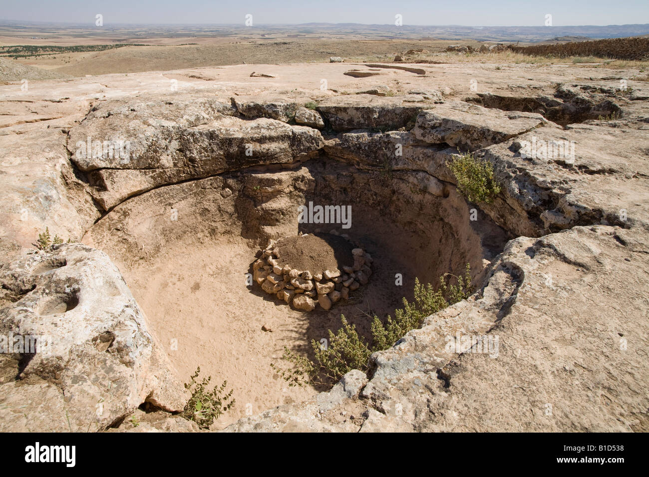 View of holes and pit in bedrock at The Neolithic site of Gobekli Tepe ...