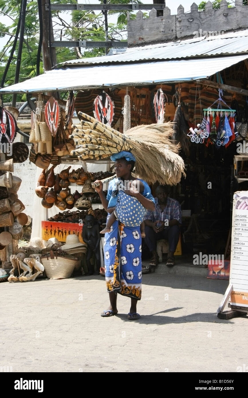 Multitasking African woman with baby Stock Photo - Alamy