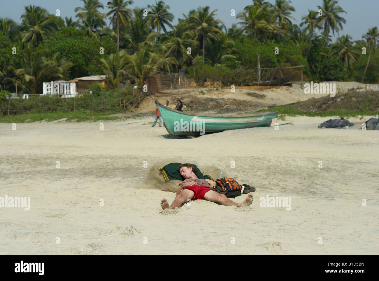 man sleeping on beach Stock Photo - Alamy