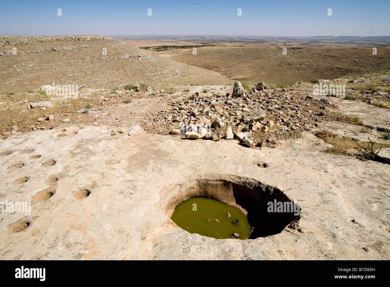 View of holes and pit in bedrock at The Neolithic site of Gobekli Tepe ...