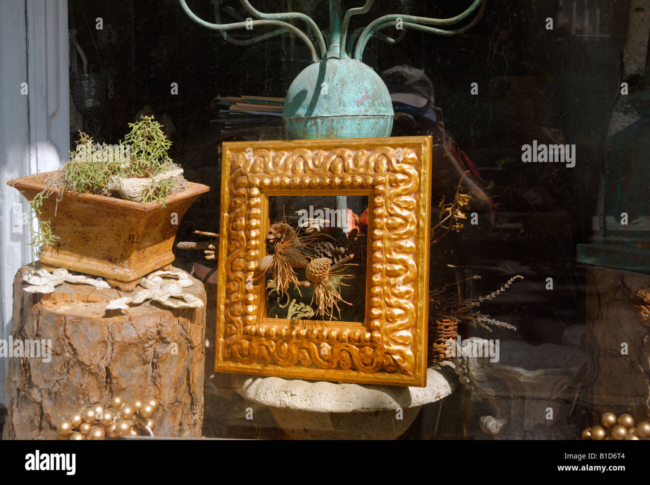 An ornate gold frame in the window of an antique shop in New York City ...