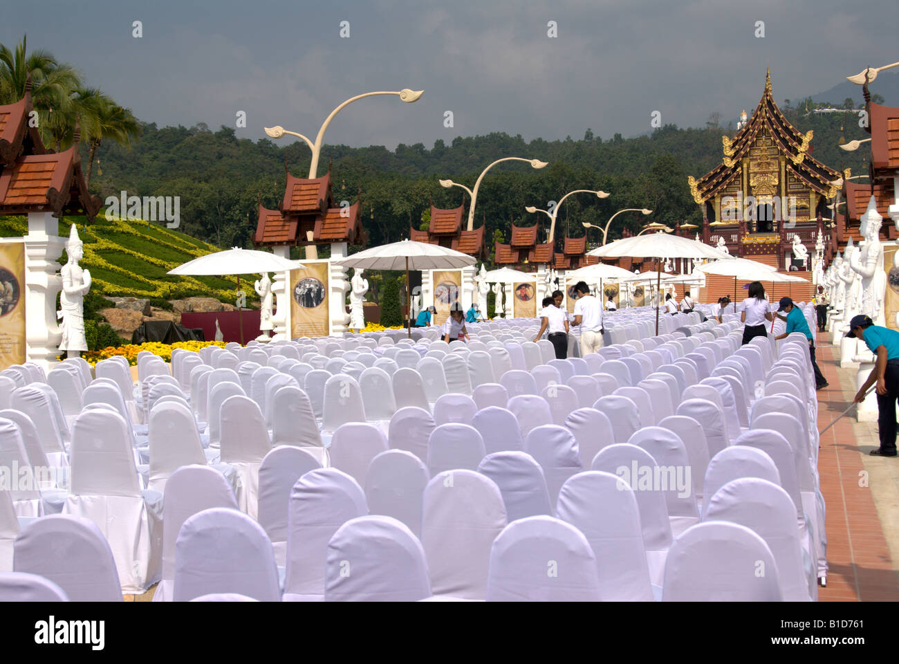 Ornate Buddhist building with rows of covered chairs in preparation for ...