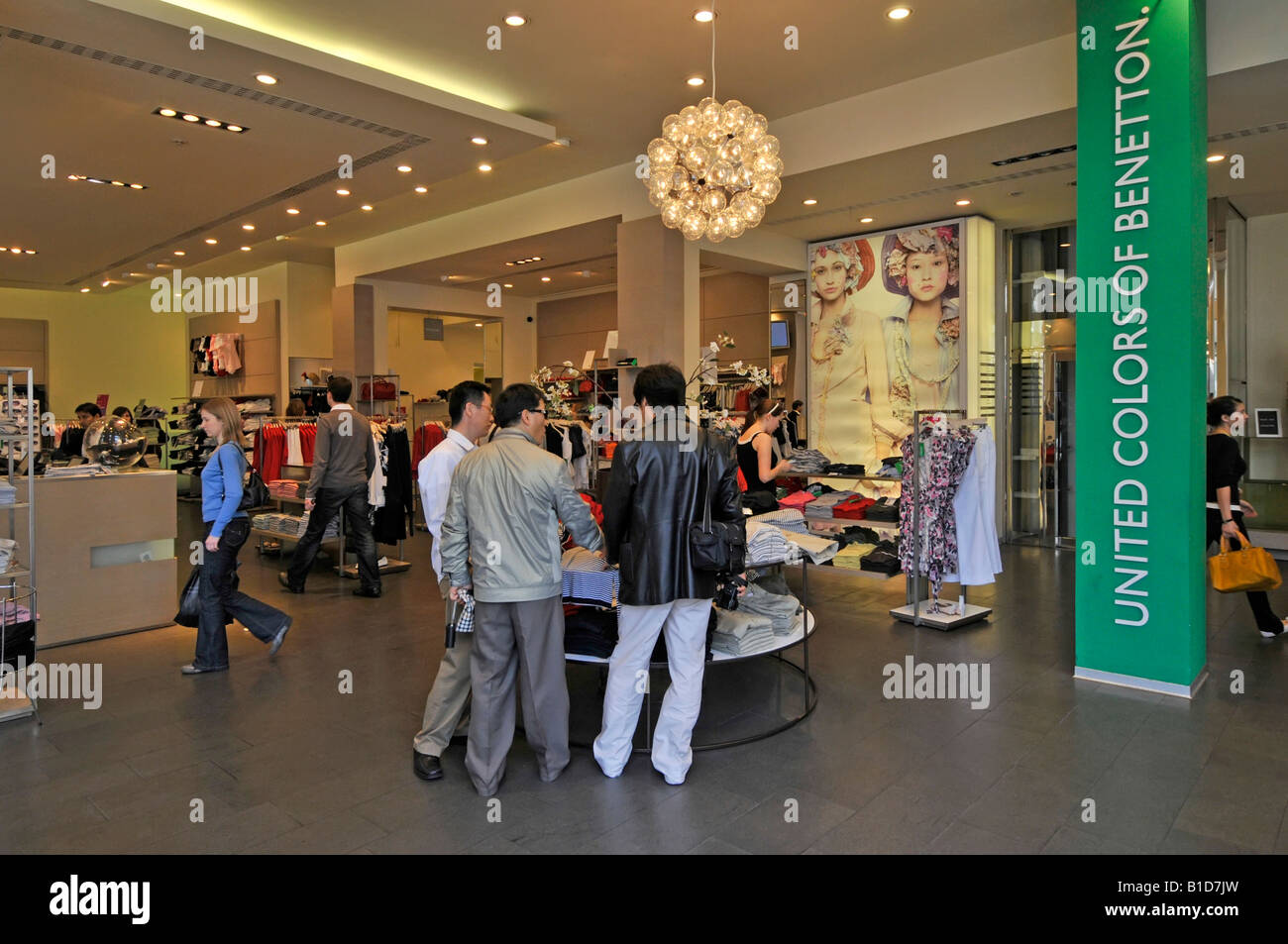 Interior of Benetton clothing shop store & shoppers seen from pavement ...