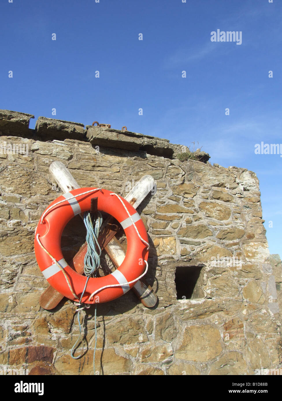 rubber ring on wall by sea Stock Photo - Alamy