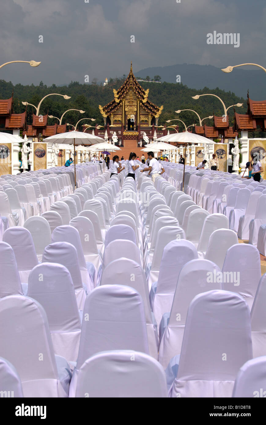 Ornate Buddhist building with rows of covered chairs in preparation for ...