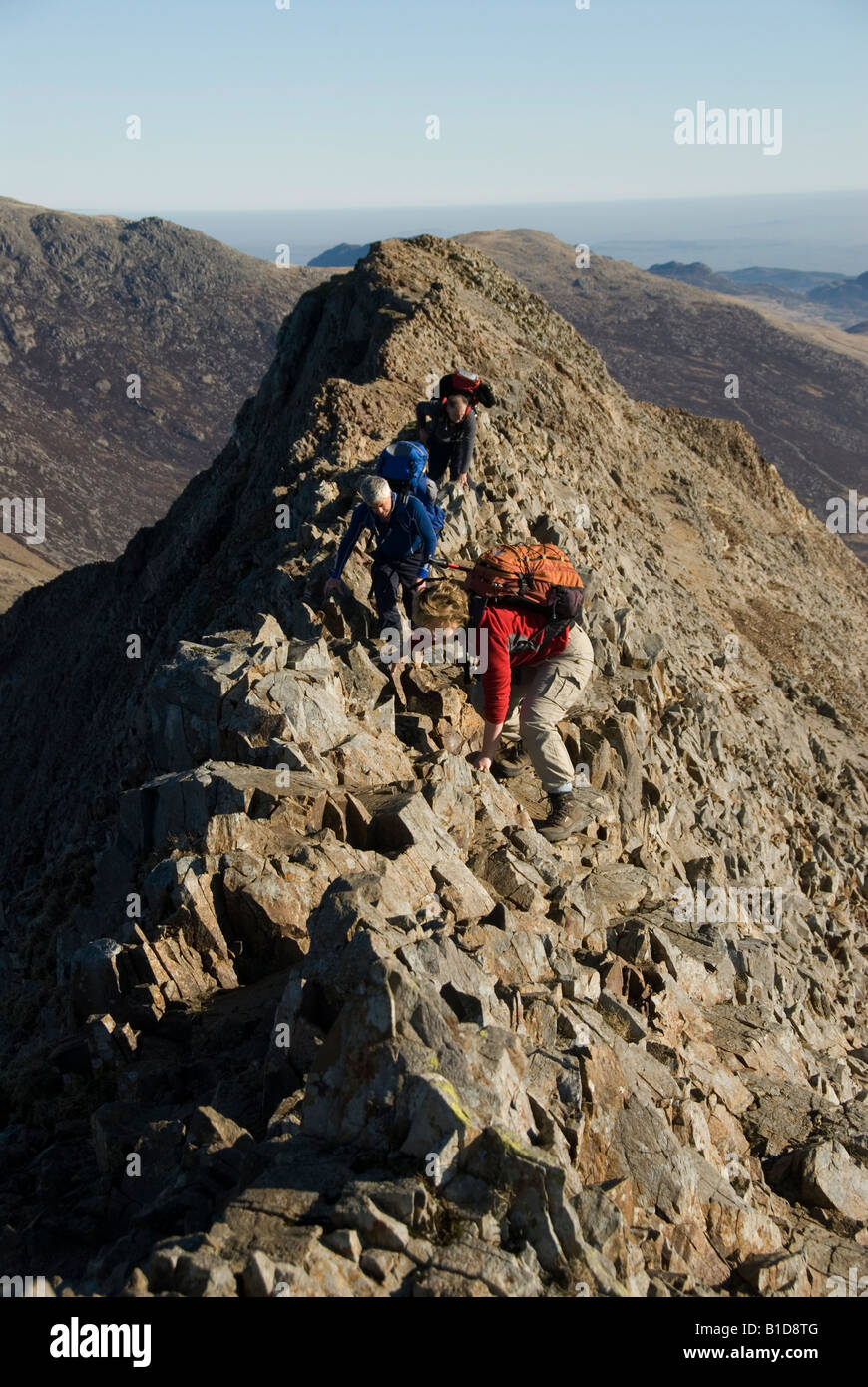Walkers on the ridge of Crib Goch Snowdonia Stock Photo - Alamy