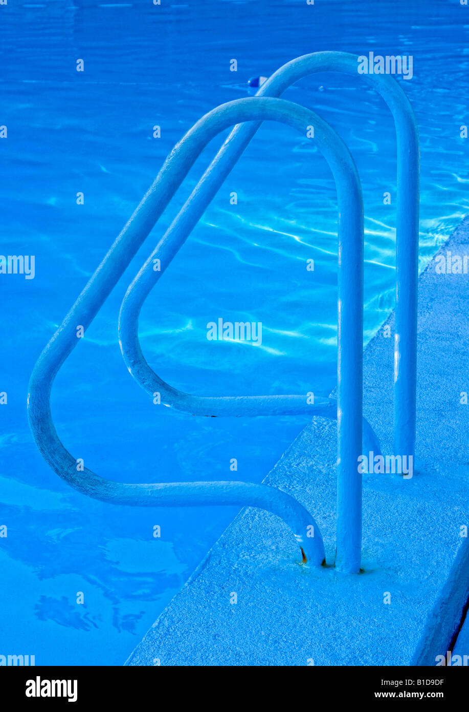 Graphic blue image of swimming pool ladder Stock Photo - Alamy