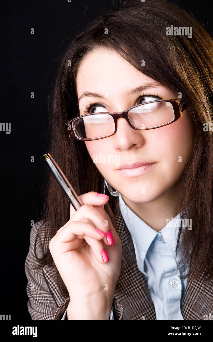 Young teacher holding pen On dark background Stock Photo - Alamy