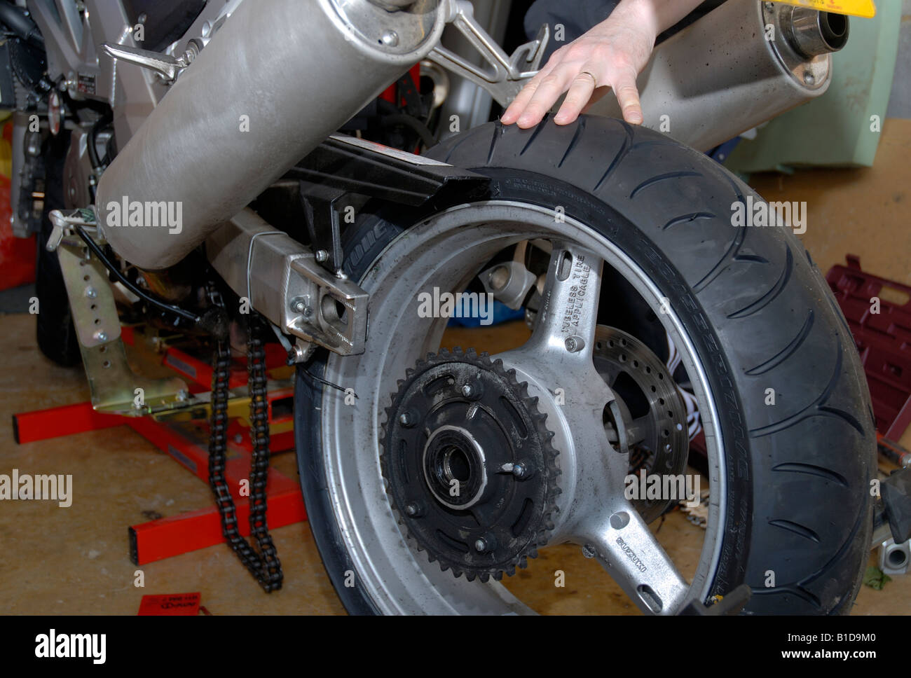 Changing Wheel on a Motorbike Stock Photo - Alamy