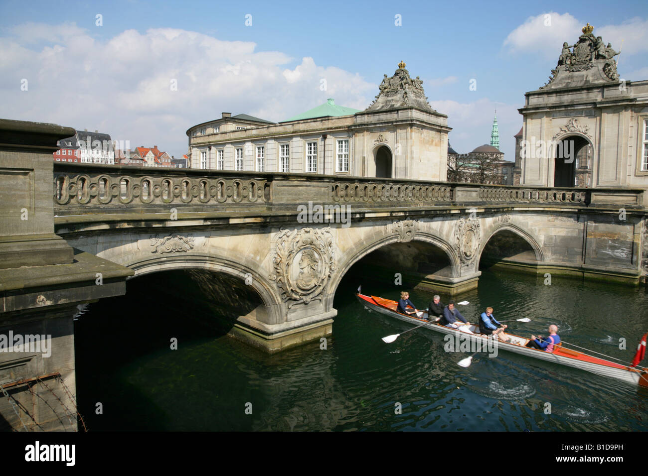 Rowers passing under the low and narrow Stormbroen bridge, Copenhagen ...