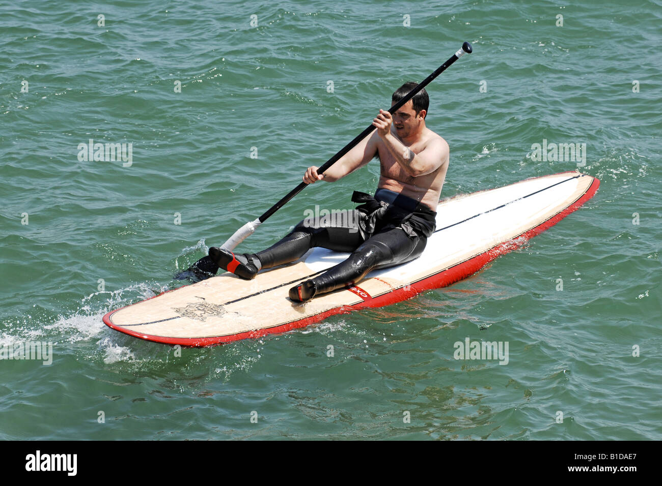 Man paddling surfboard kayak hi-res stock photography and images - Alamy