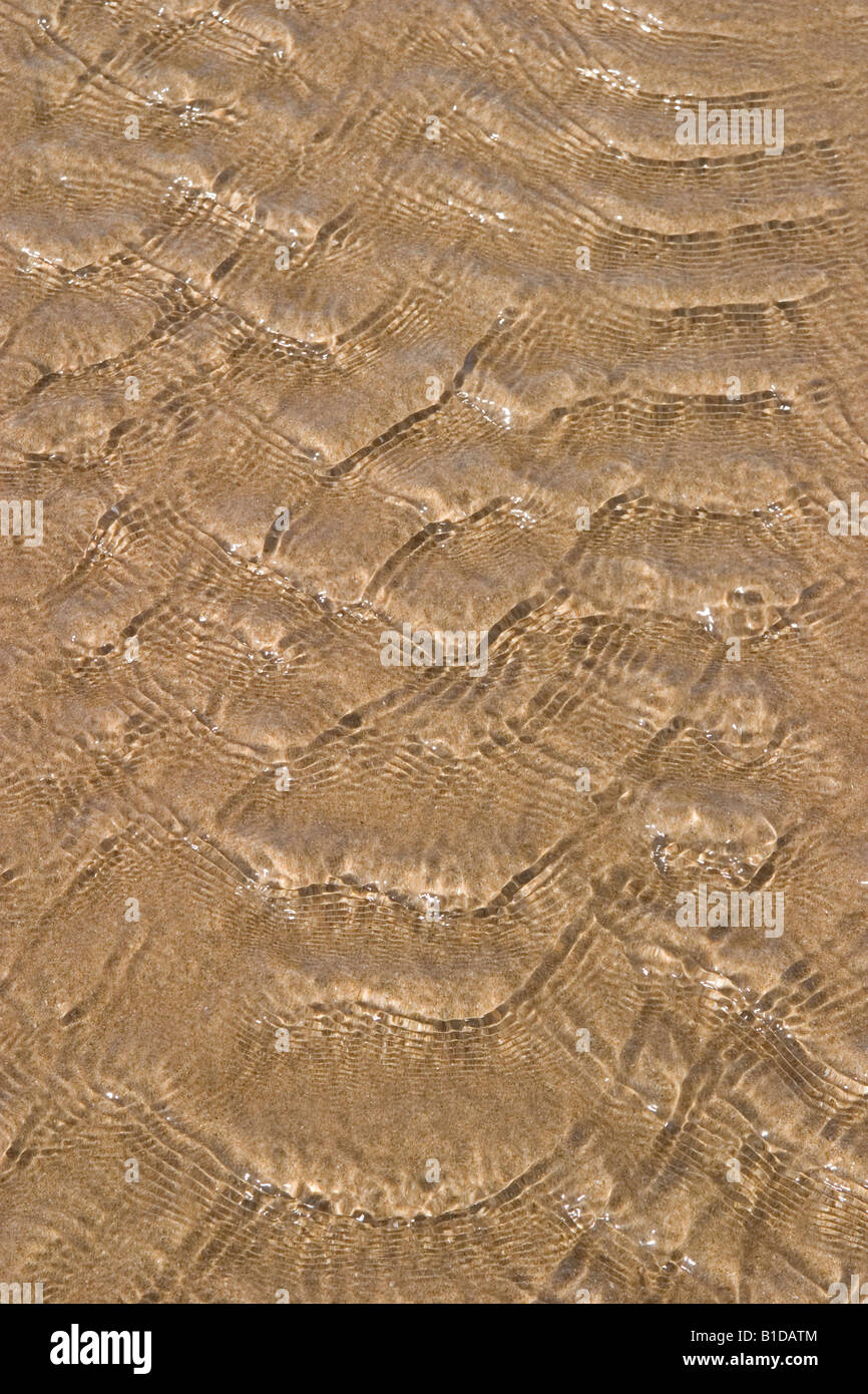 rippling water patterns over sand on beach Stock Photo - Alamy