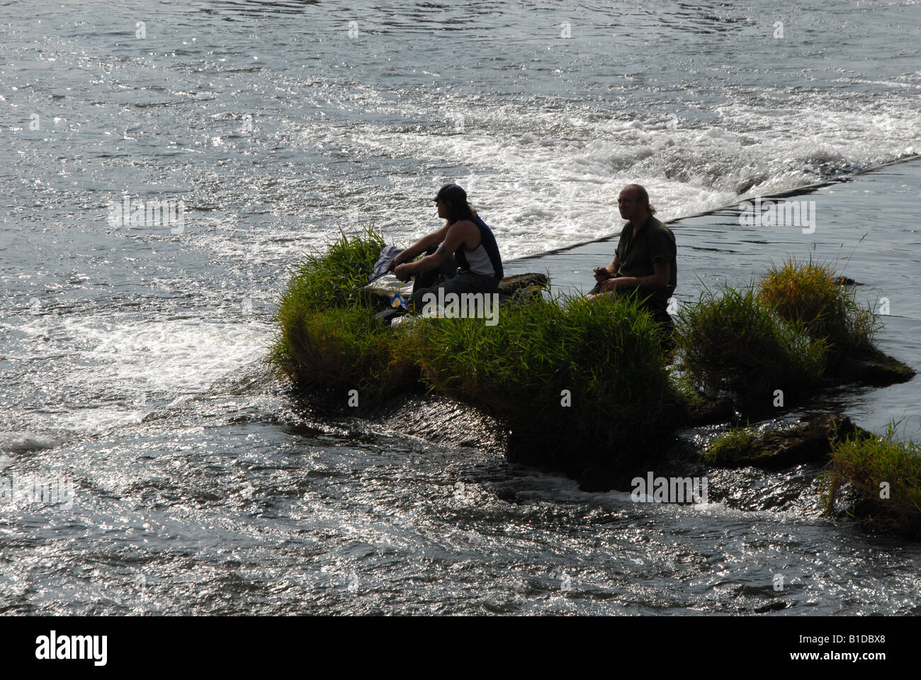 Two fisherman fishing on the river Stock Photo - Alamy