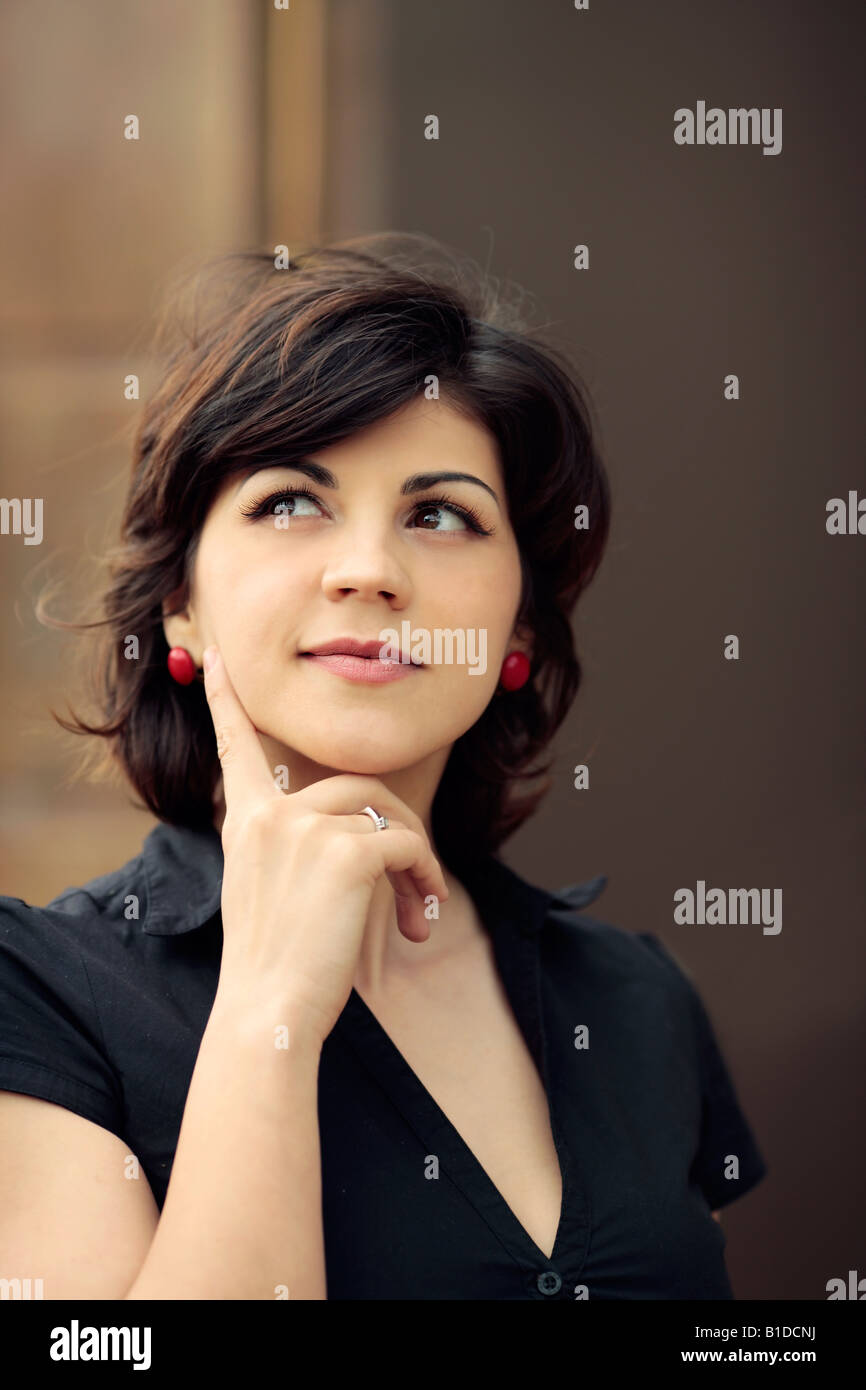 young attractive lady thinking,like having and idea and looking high up ...