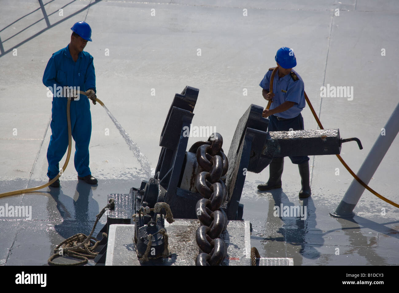 Washing the anchor chain as it is winched in on Cunard QE2 Stock Photo ...