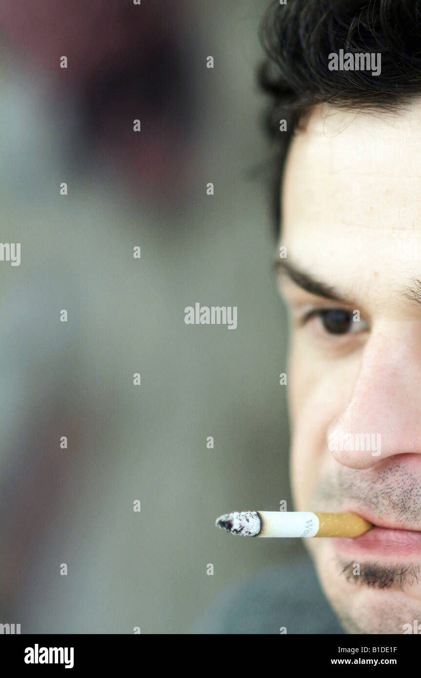 Man smoking a cigarette Stock Photo - Alamy