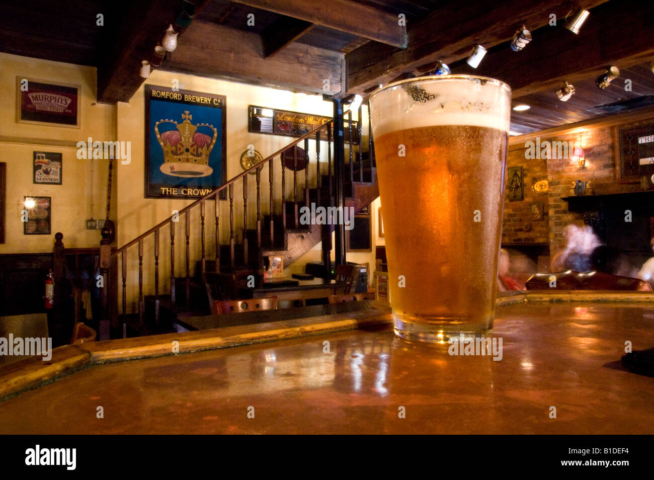 A cold pint of Boddington beer sits on a table in a British style pub ...