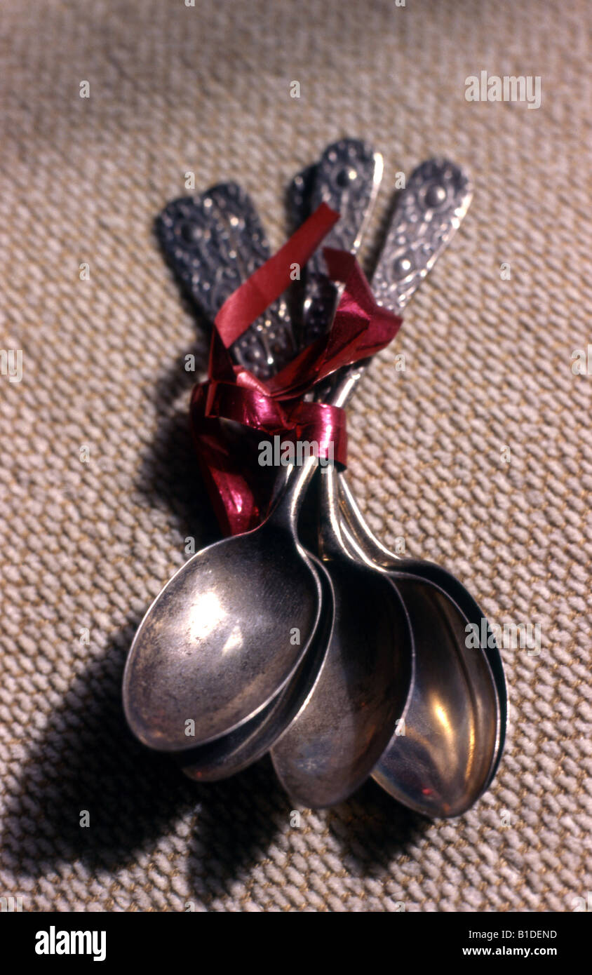 Five antique spoons tied together with a red ribbon Stock Photo - Alamy