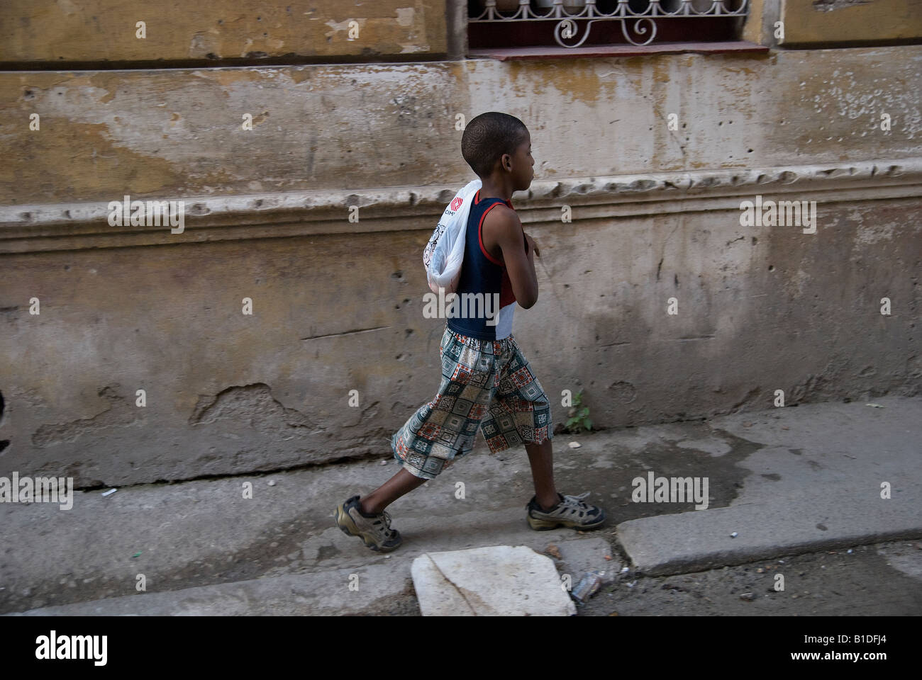 Little cuban boy walks on the street of La Habana Vieja Stock Photo - Alamy