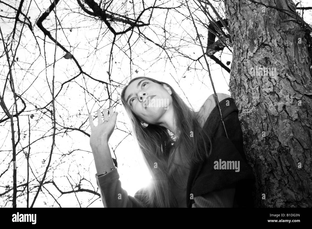 Young woman posing by a tree MODEL RELEASED Stock Photo - Alamy