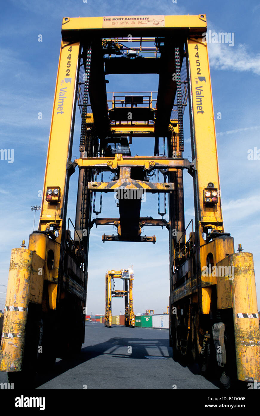 Straddle carrier lift on pier or port for moving cargo containers ...