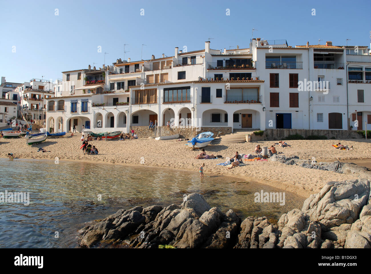 Fishing boats and sun bathers at Port Bo at Calella Palafrugel Spain ...