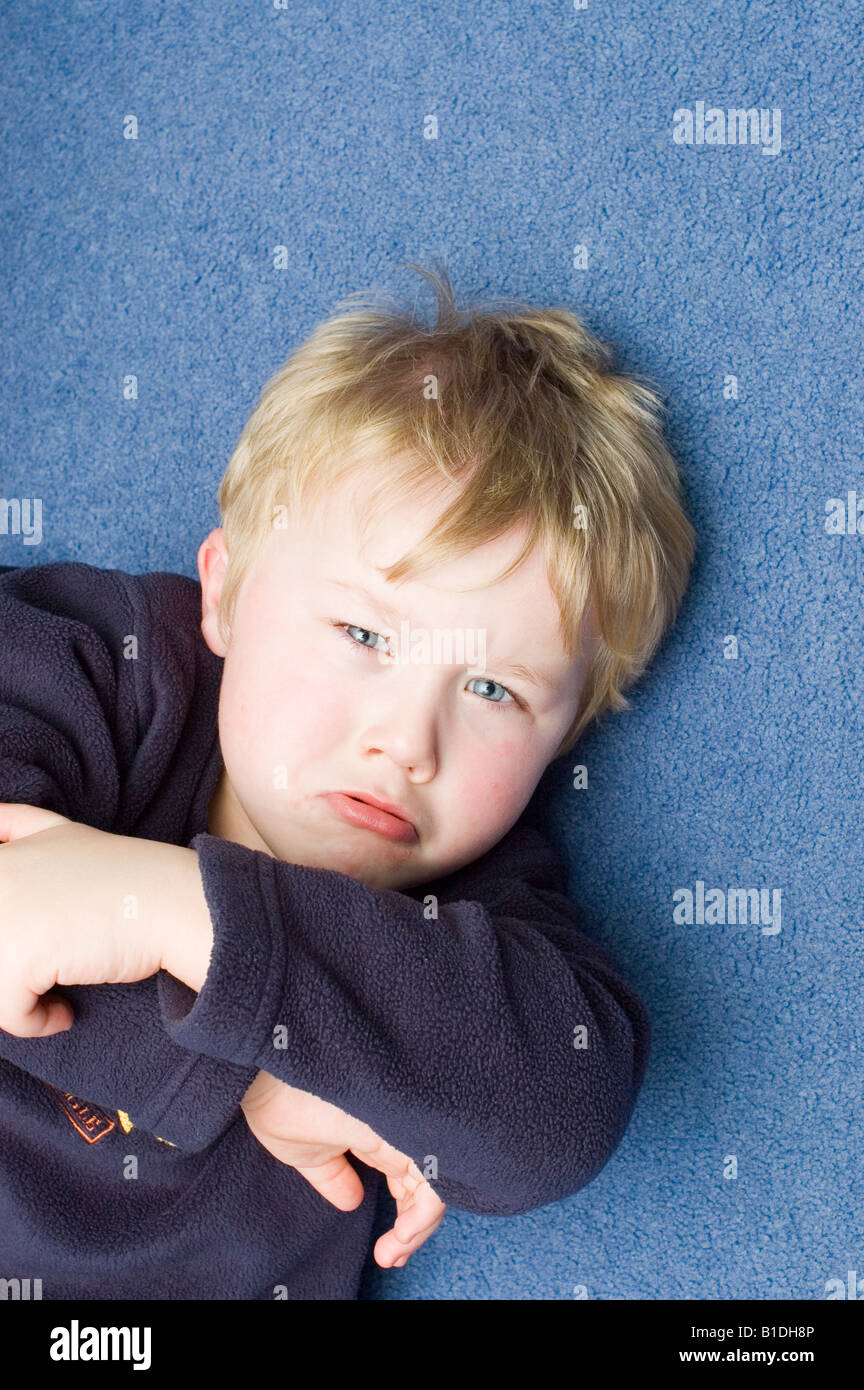 Grumpy Four Year Old Boy with blond hair Stock Photo - Alamy
